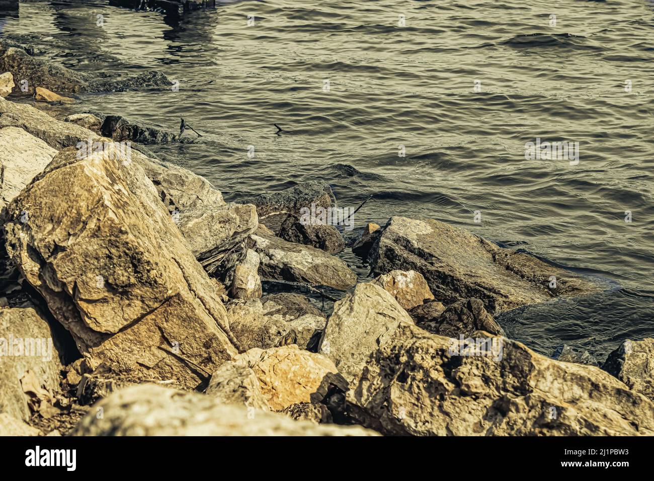 Water floats on the boat landing rocks Stock Photo - Alamy