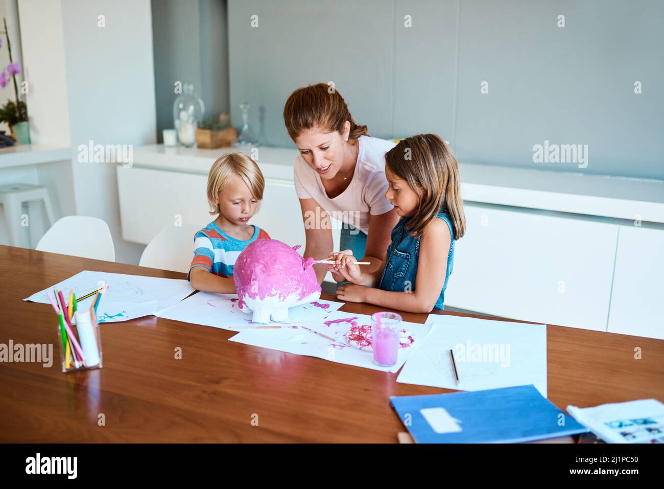 Moms always make the best teachers. Shot of a young mother helping her ...
