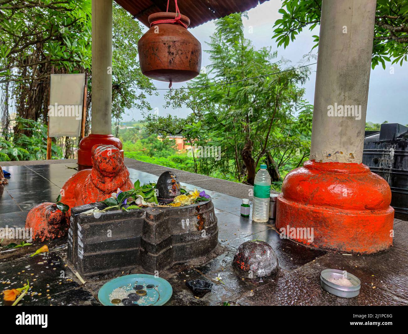 The ancient shivling made of black stone with bull statue, clay pot ...