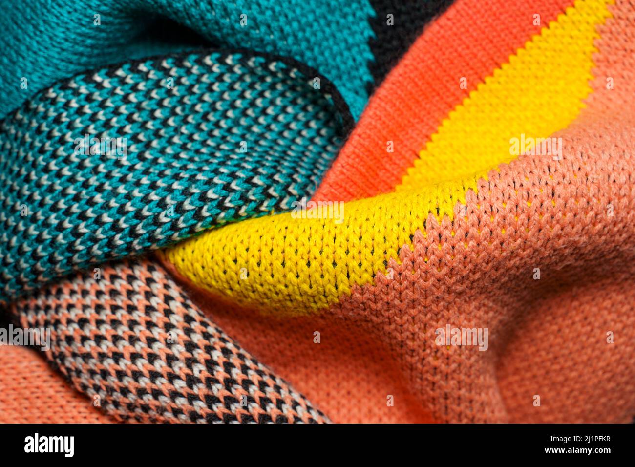 A pile of multi-colored synthetic knitted fabrics of different ...