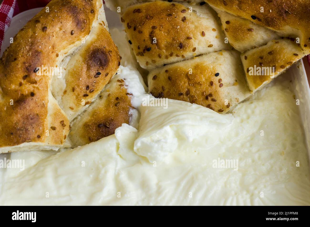 Two slices of Traditional Turkish Ramadan Bread,Pide in fresh yogurt ...