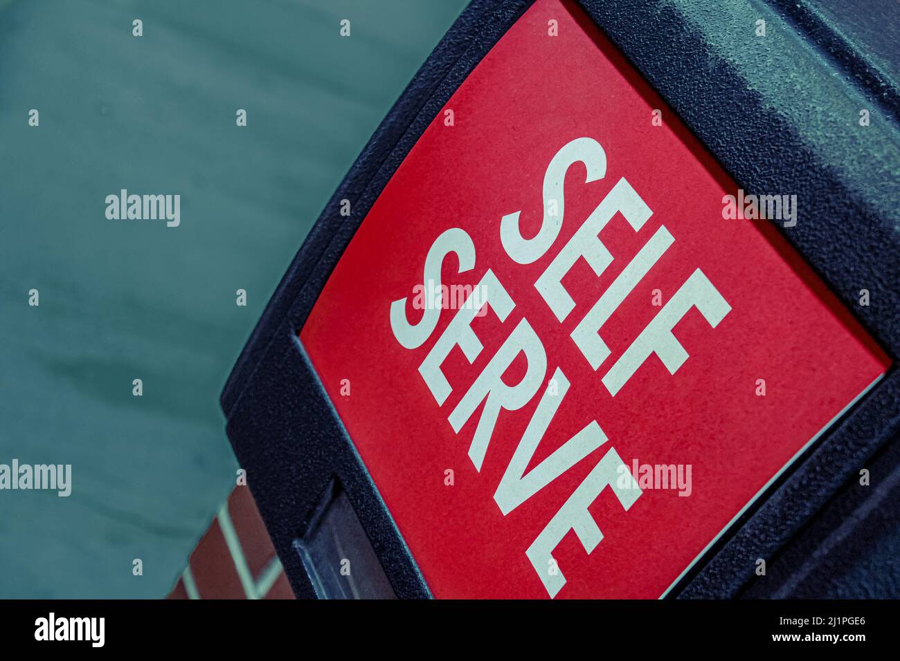 Bright red gas station sign for self serve Stock Photo - Alamy
