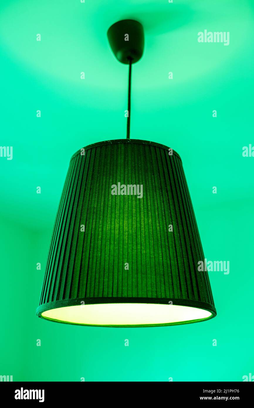 Luminous lamp under the ceiling in green Stock Photo - Alamy