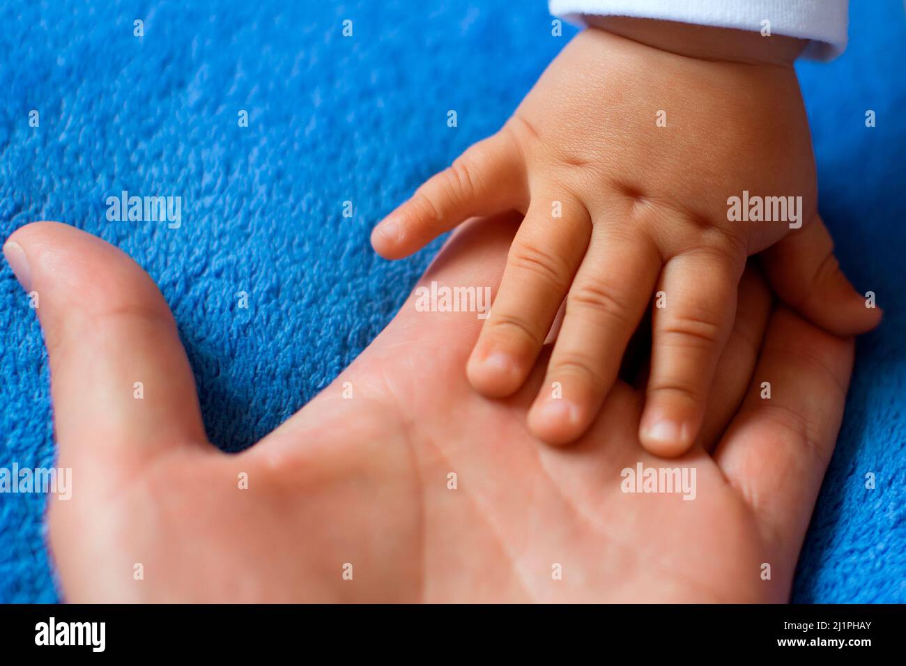 Hand of a child on a woman's palm Stock Photo - Alamy