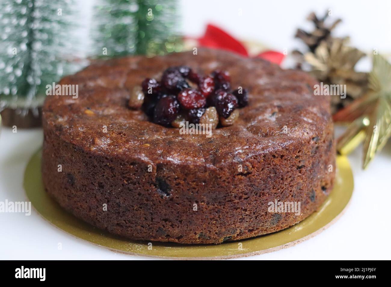 Rich Plum cake with fruits soaked in rum. Topped with rum soaked dried ...