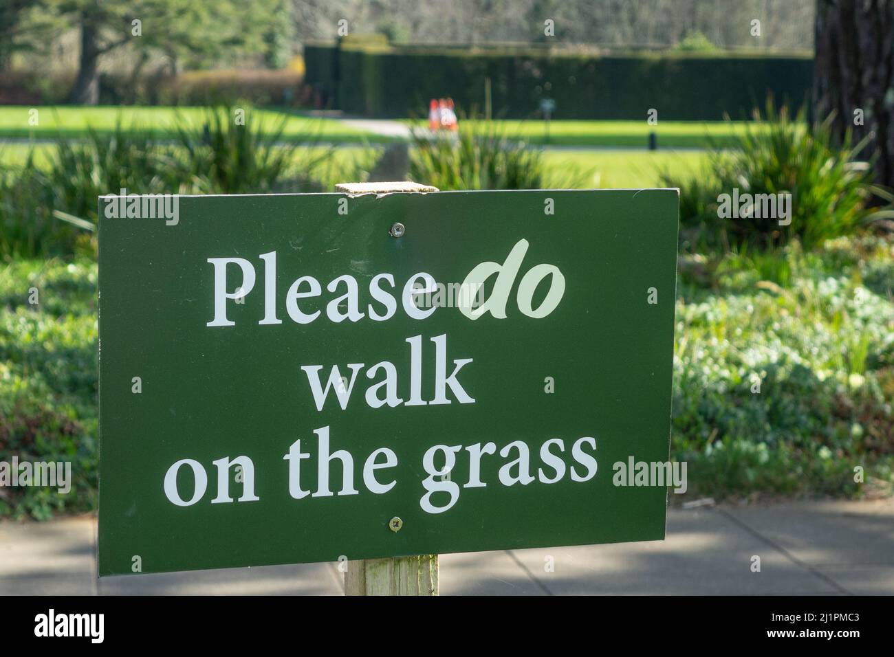 Sign. Please DO walk on grass Stock Photo - Alamy