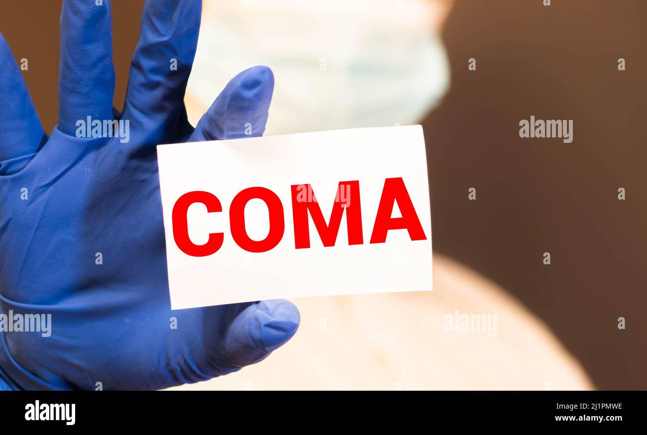 Hand writing COMA with the abstract background. The word COMA represent ...