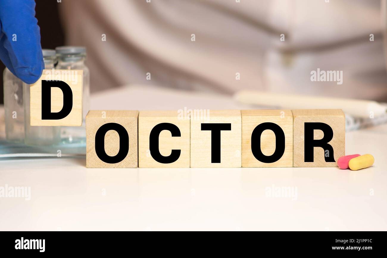 doctor word on white paper is putted in a pocket of a doctor's wearing ...