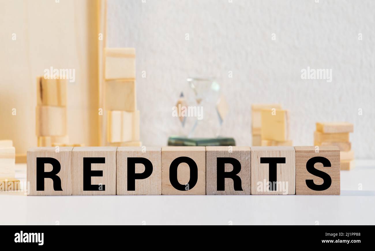 REPORTS word written on wood block. REPORTS text on table, concept ...