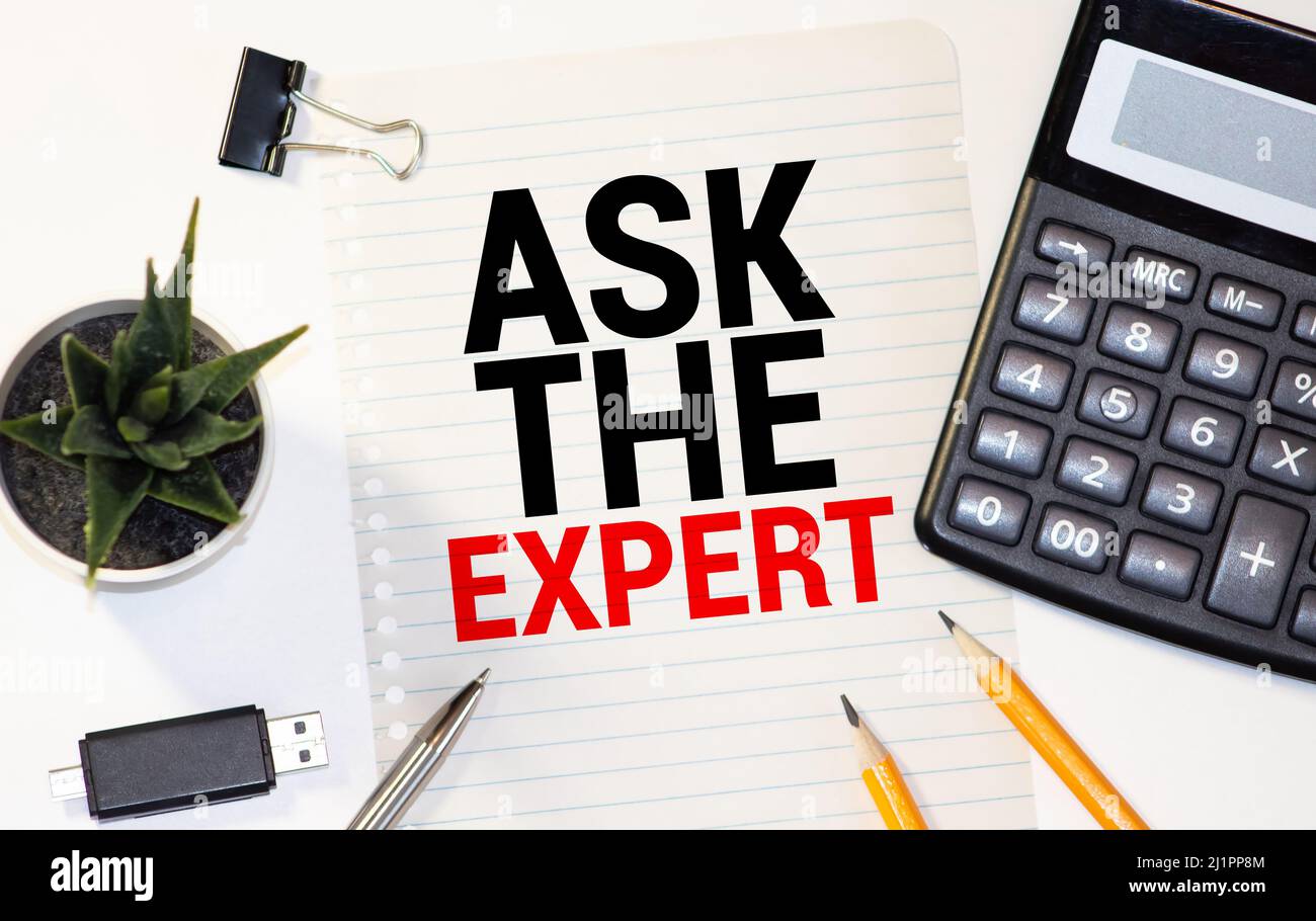 Ask an expert. Top view of working place with ask an expert lettering ...