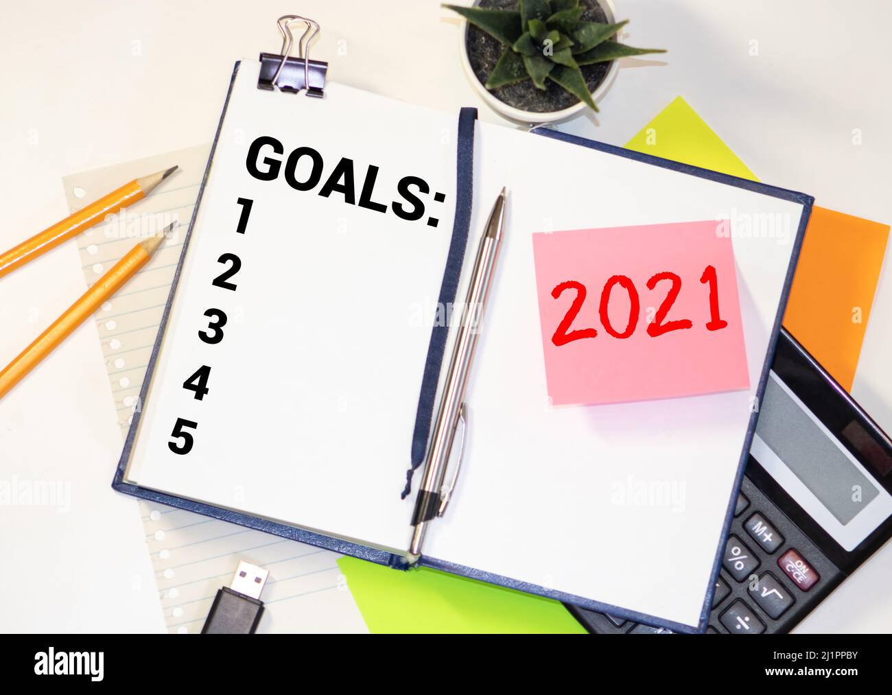 GOALS 2021 words written on a white piece of paper laid on a wooden ...