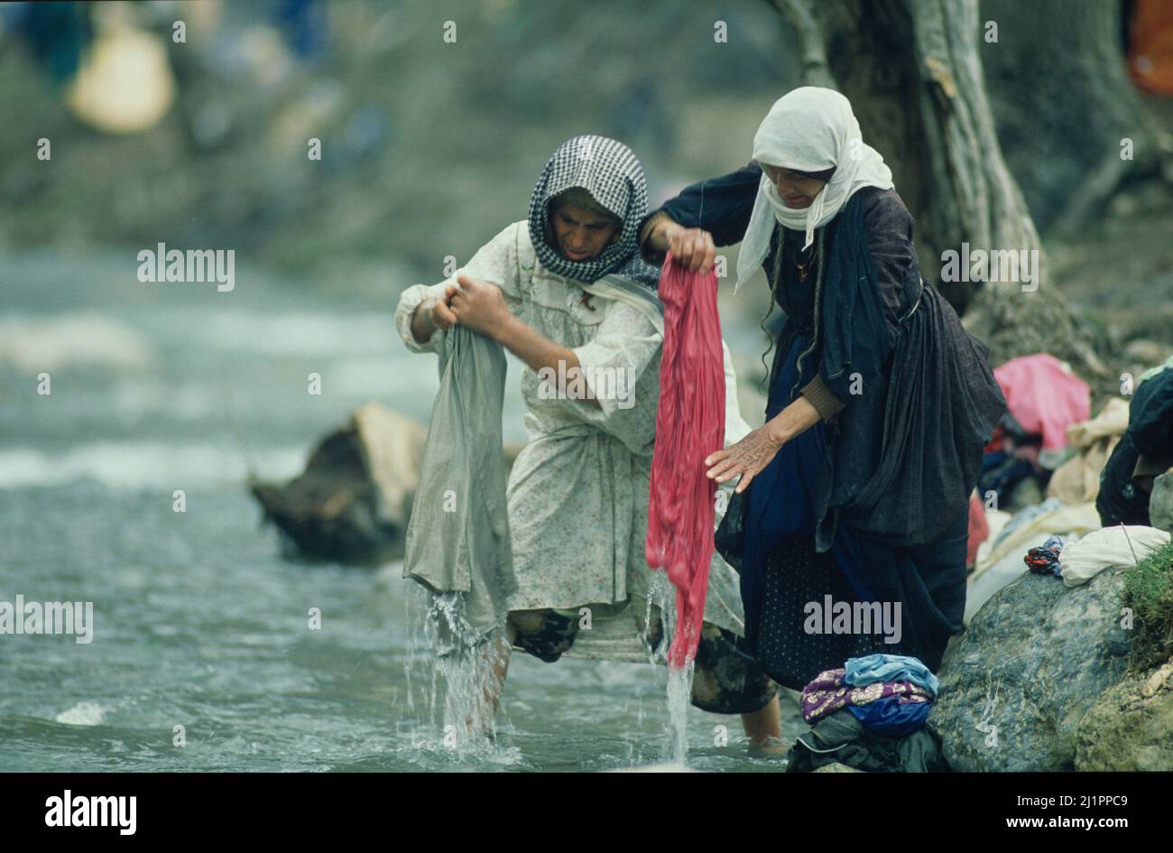 Kurdish Refugees wash their clothing in a river in Isik Veren Mountain ...