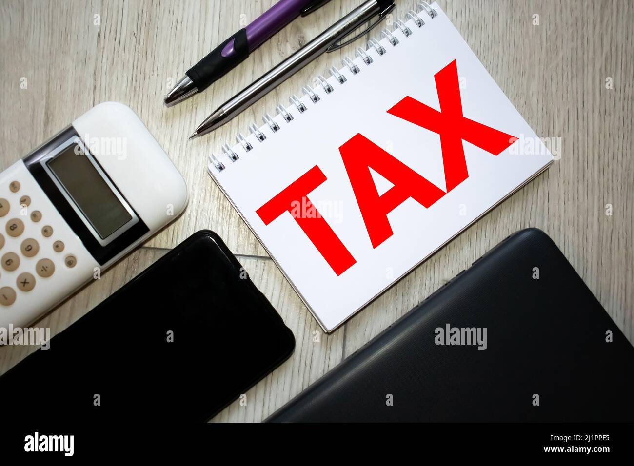 TAX Business team hands at work with financial reports and a laptop ...