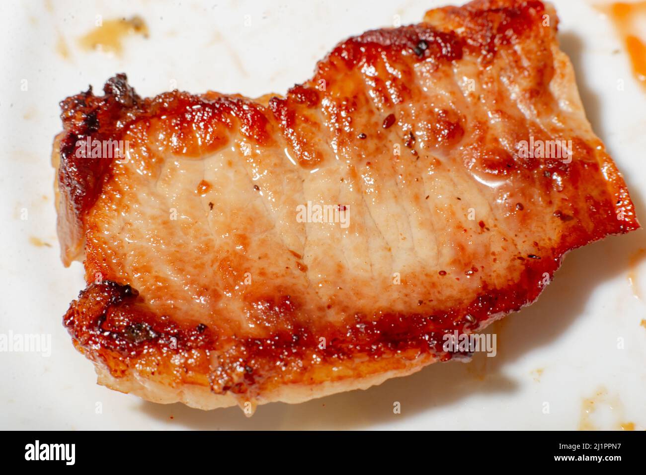 Texture of fried meat close up. A fatty piece of pork at a large ...