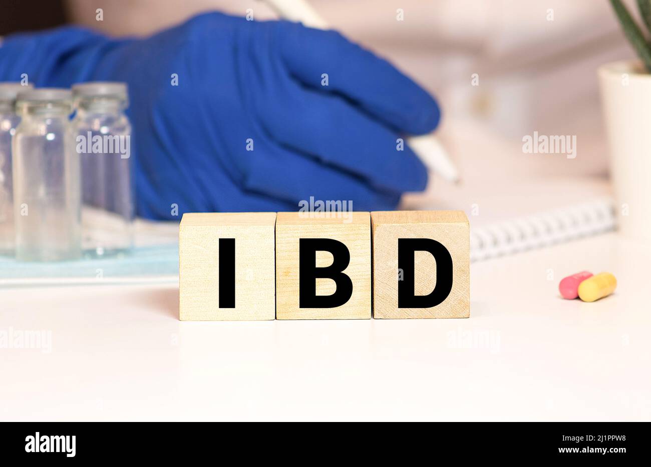 IBD acronym cut from newspaper on white handmade paper texture Stock ...