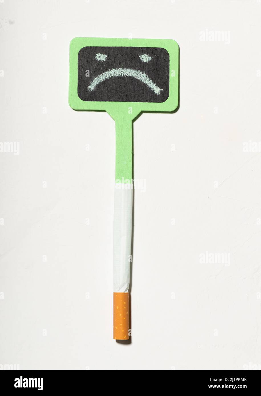 Harm of smoking concept. Unhappy smiley and ashtray with cigarette ...