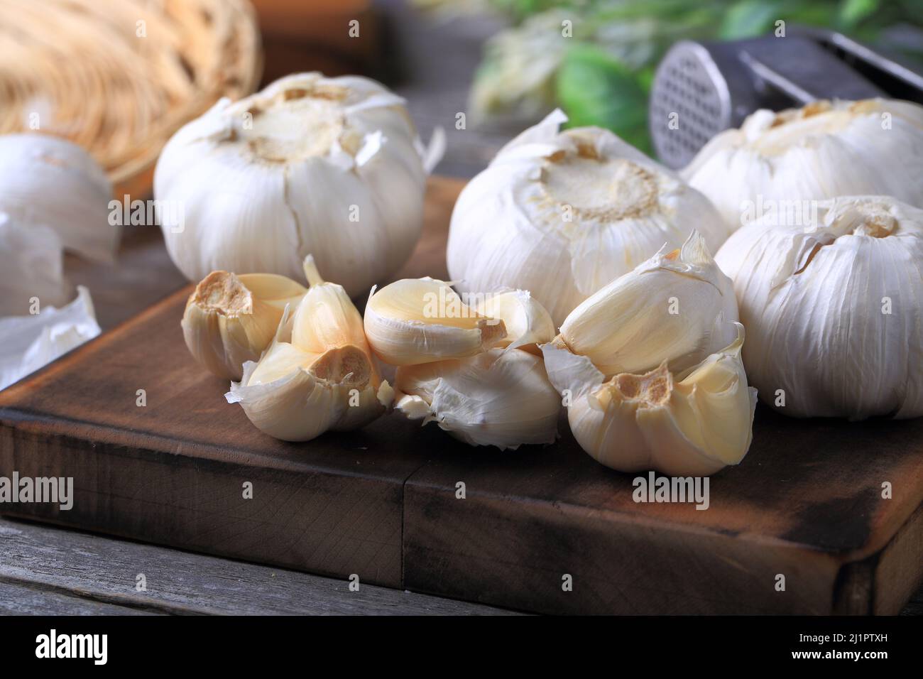 Garlic Cloves and Bulb on Wooden Background Stock Photo - Alamy