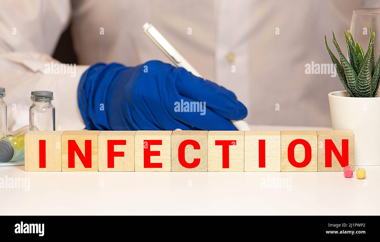 INFECTION text made in building wood blocks Stock Photo - Alamy