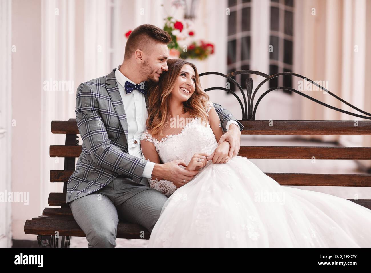 wedding day. beautiful bride in white long dress and young groom ...