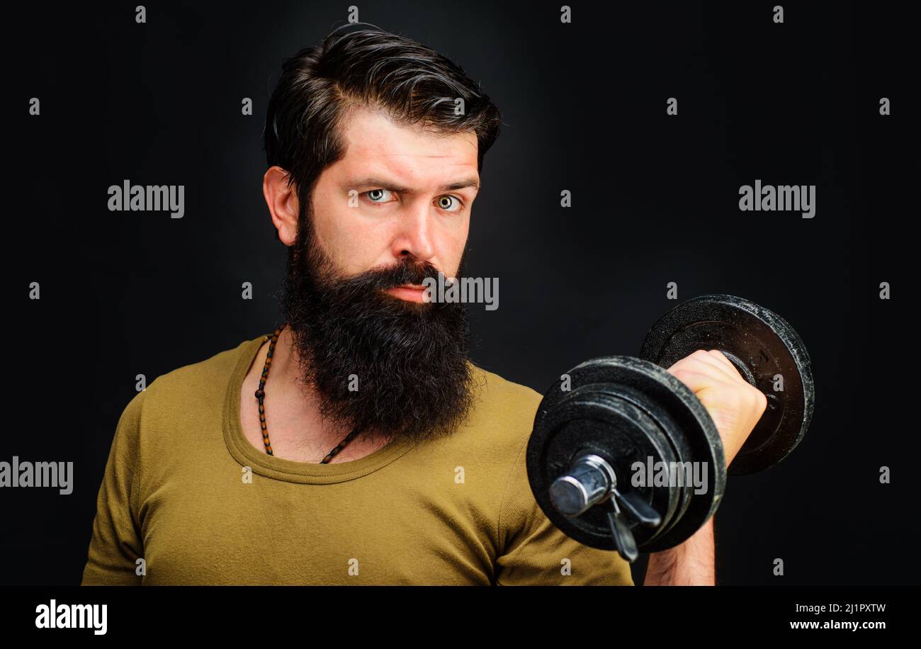 Strong muscular man with dumbbells. Athletic guy lifting dumbell ...
