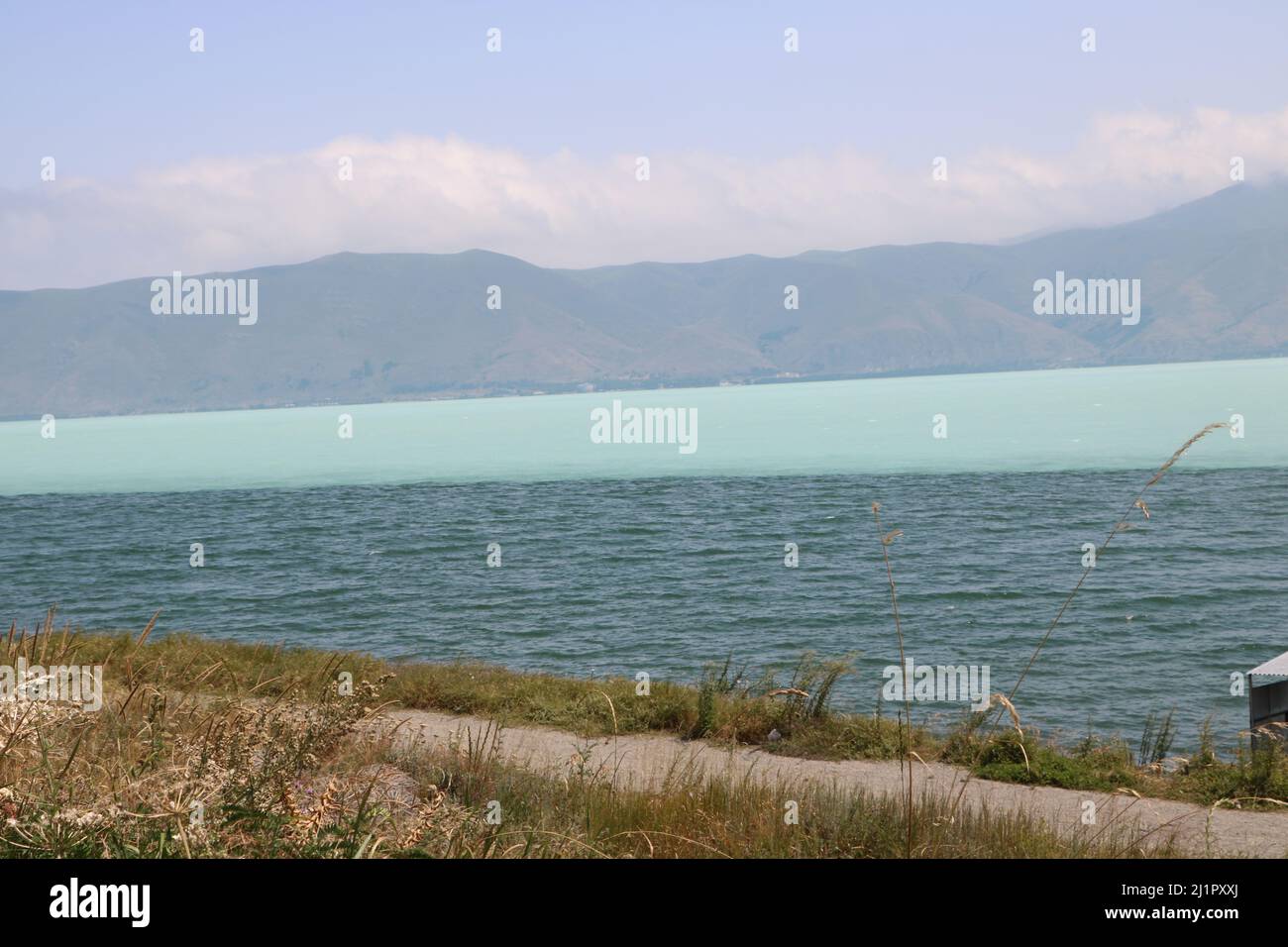 A beautiful scenery of lake Sevan with turquoise water and green hills ...