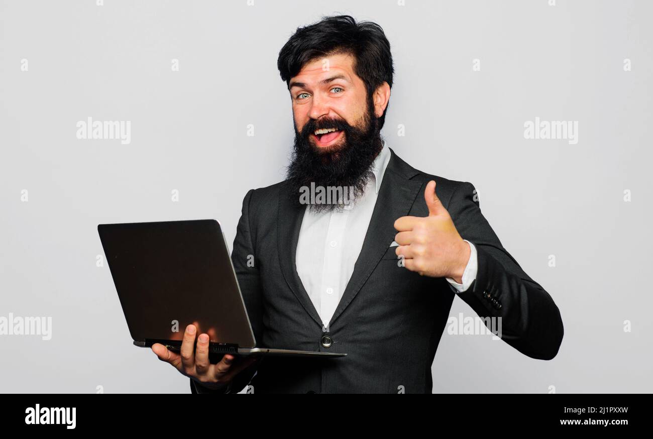 Happy bearded man with laptop computer showing thumbs up. Office ...