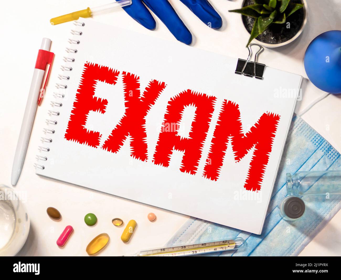 Word EXAM written in notebook on table, medical concept Stock Photo - Alamy