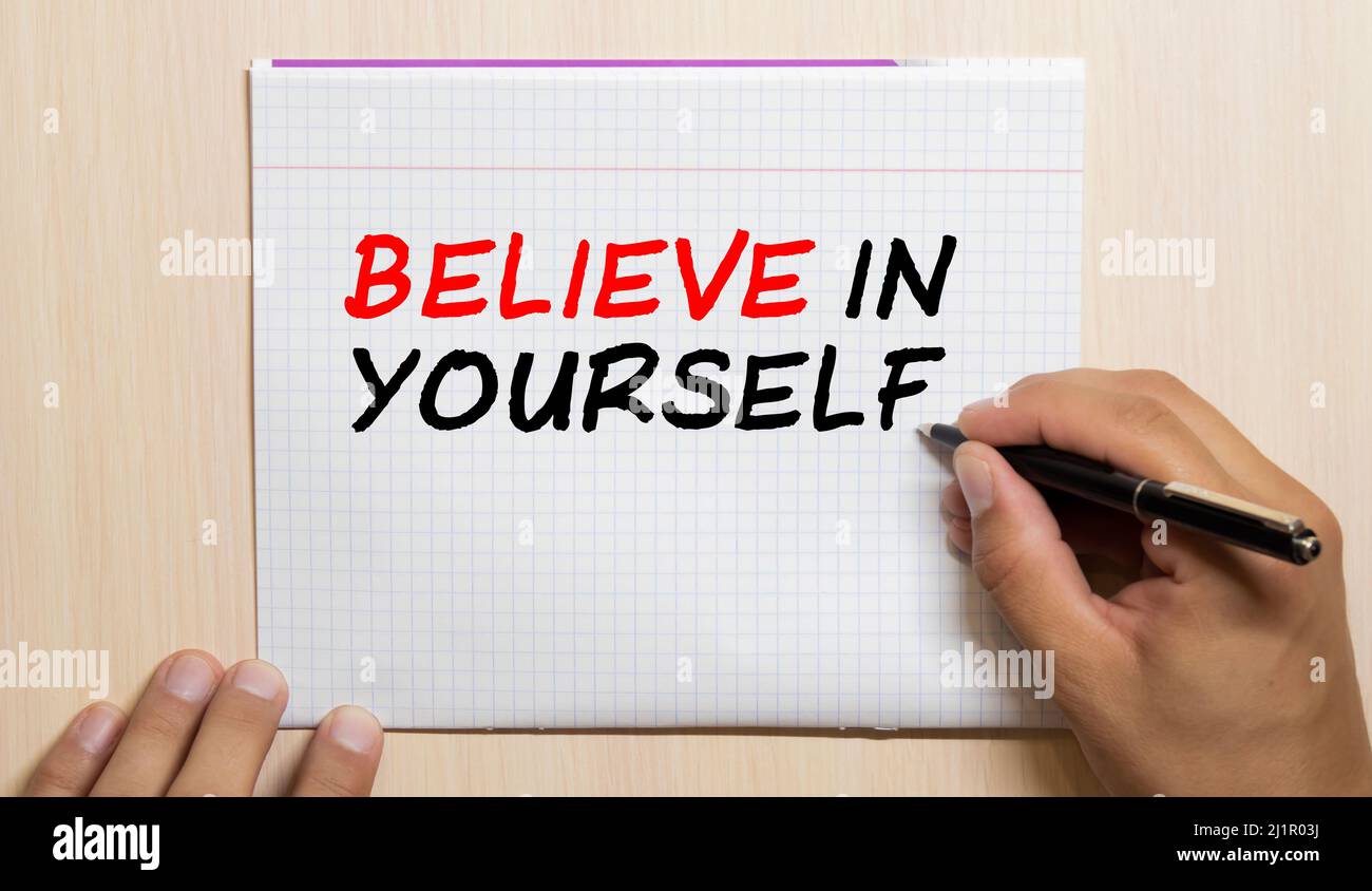 Believe in yourself. word written on a sticky note on the gray fridge ...