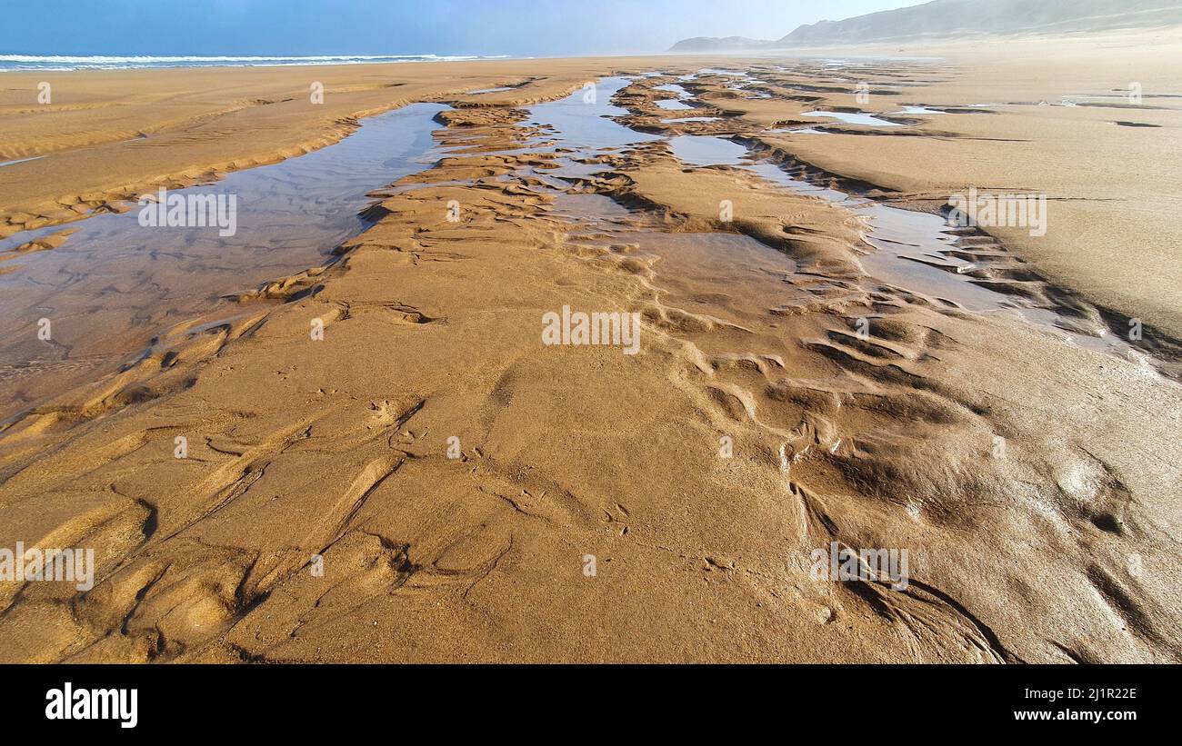 Mist over sea and sand Stock Photo - Alamy