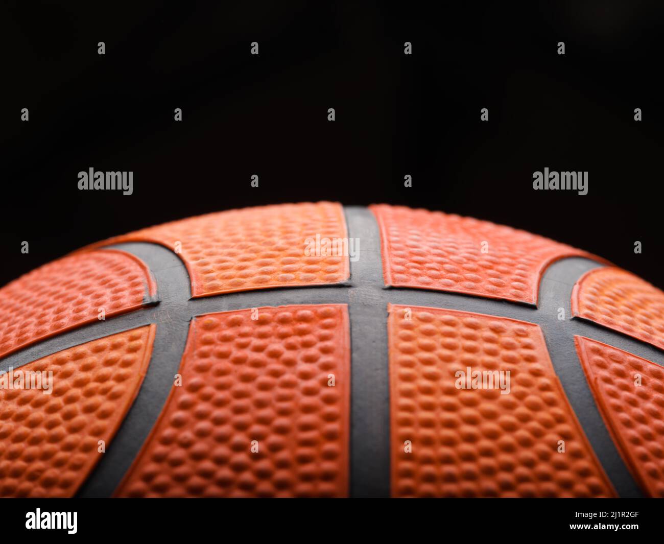 Macro shot. On a black background, details of a basketball. Sports ...
