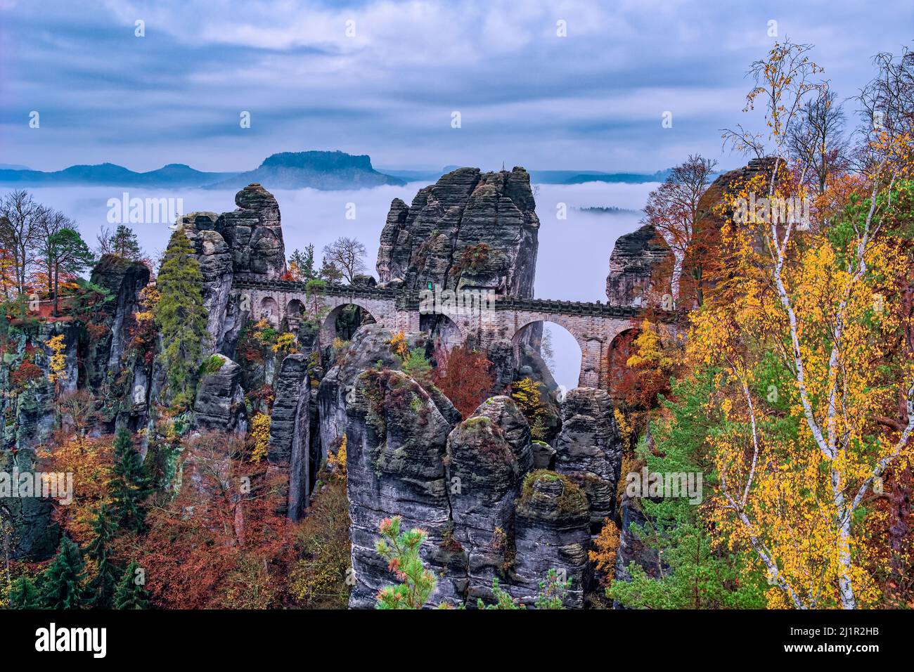 Landscape with the rock formation Bastei covered in fog in Rathen area ...