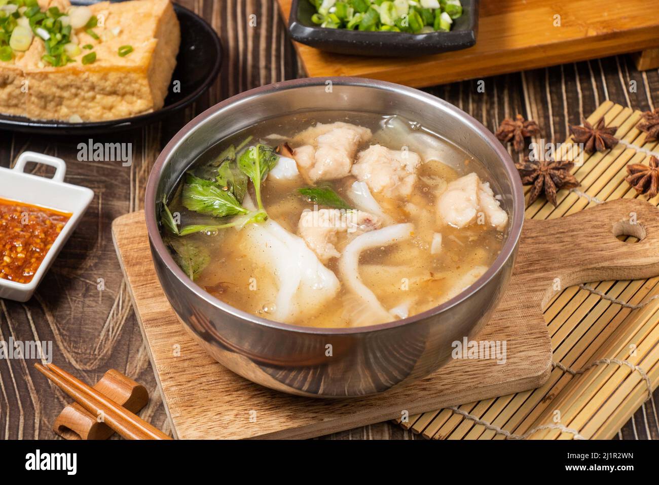 squid soup slabs in a bowl isolated on wooden board side view on table ...