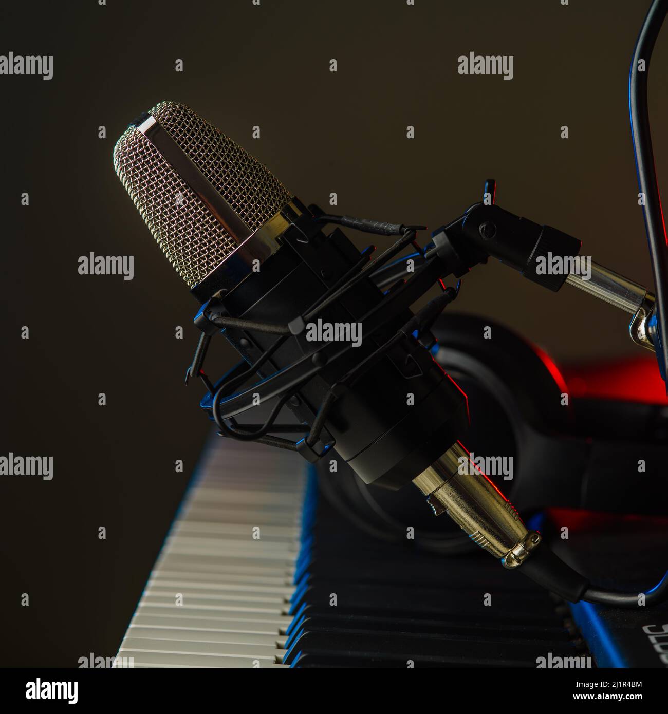 Recording studio. Modern synthesizer, midi keyboard and microphone on a ... Recording studio. Modern synthesizer, midi keyboard and microphone on a ...