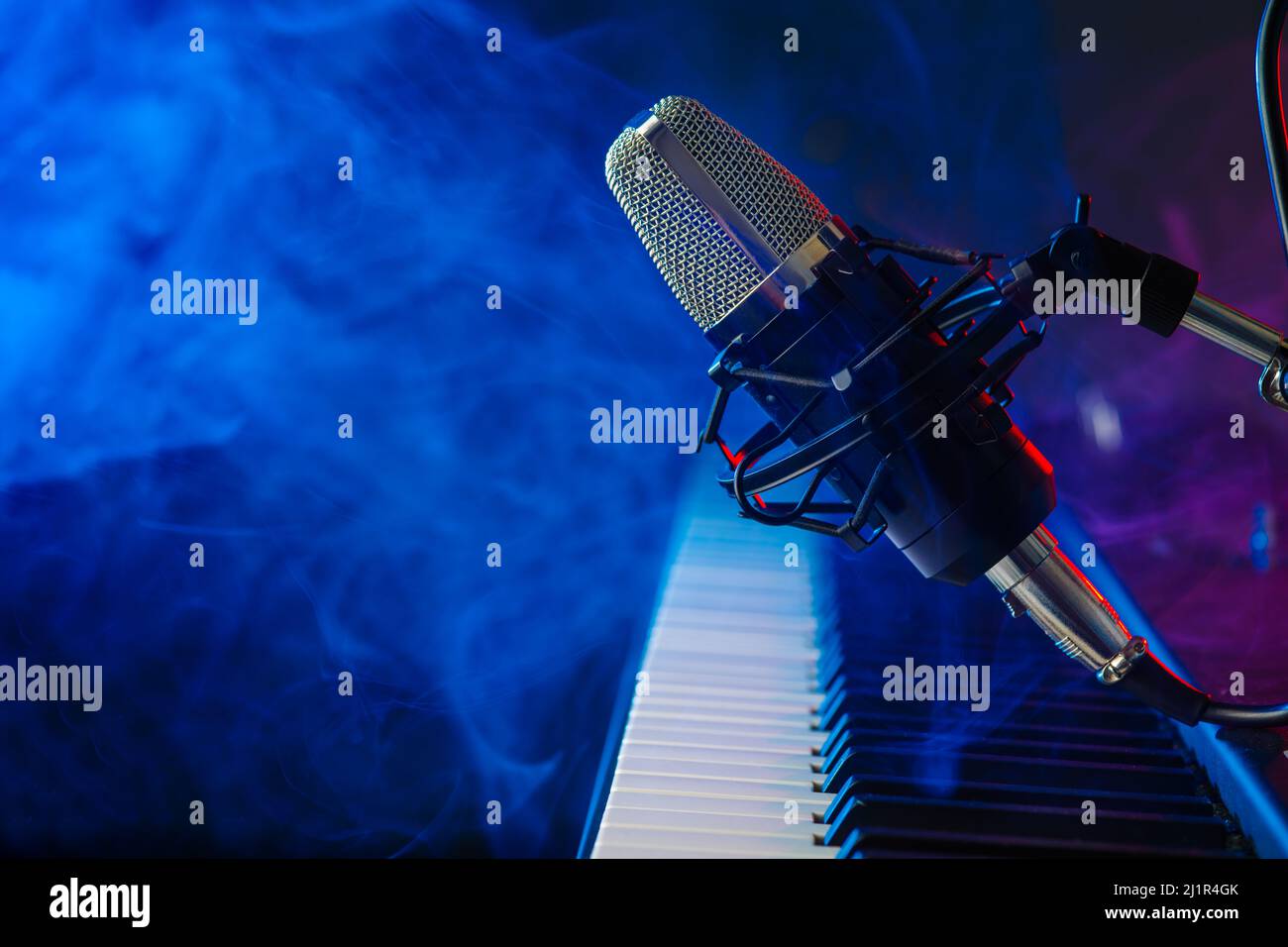 On a blue smoky background, a musical instrument is a midi keyboard and ...
