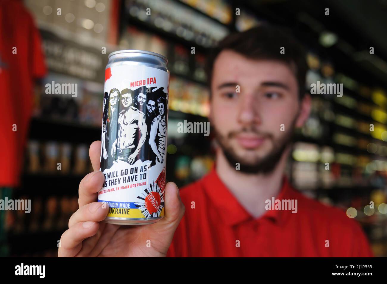 In this photo illustration, an employee holds a can of the new beer ...