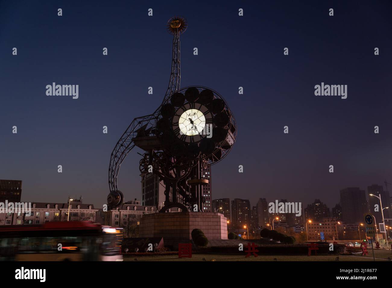 A low angle of the Tianjin clock tower in the middle of the streets of ...