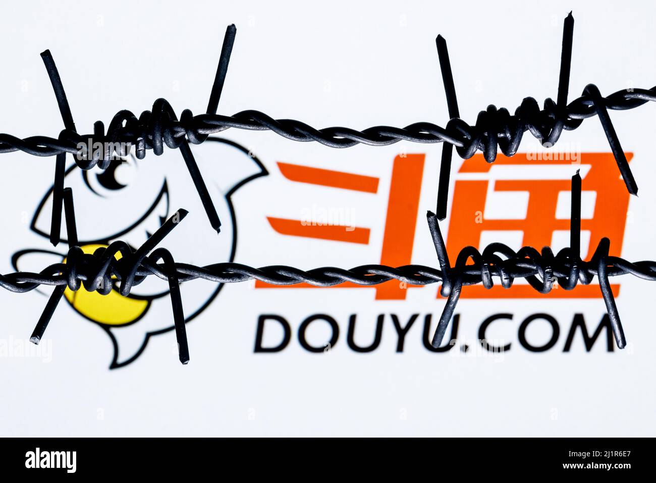 DouYu live streaming service logo behind barbed wire. The concept of ...