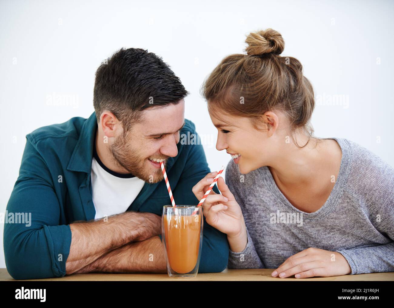Young couple sharing milkshake hi-res stock photography and images - Alamy