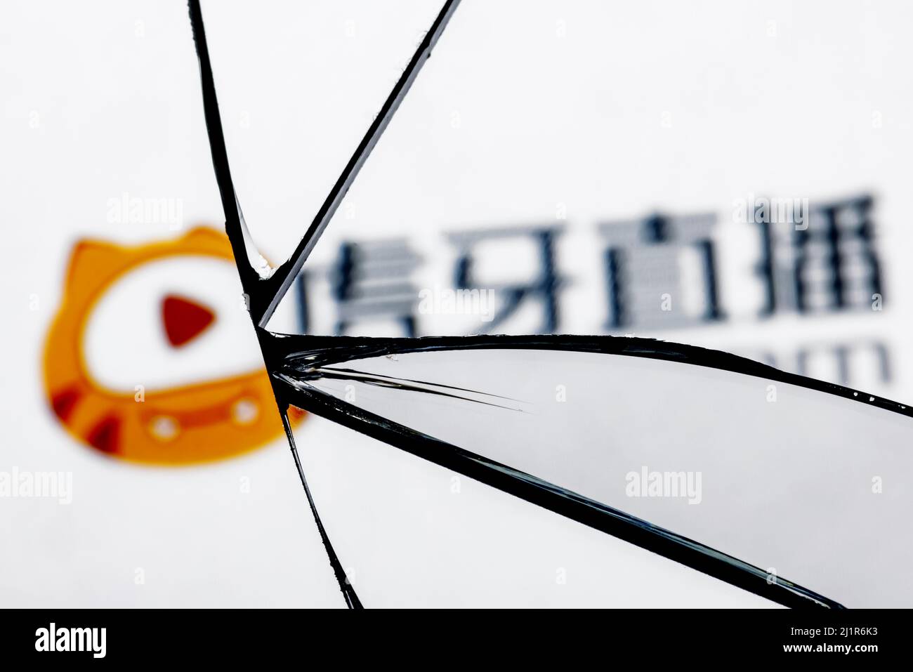Logo of the Huya live streaming service in the reflection of a broken ...