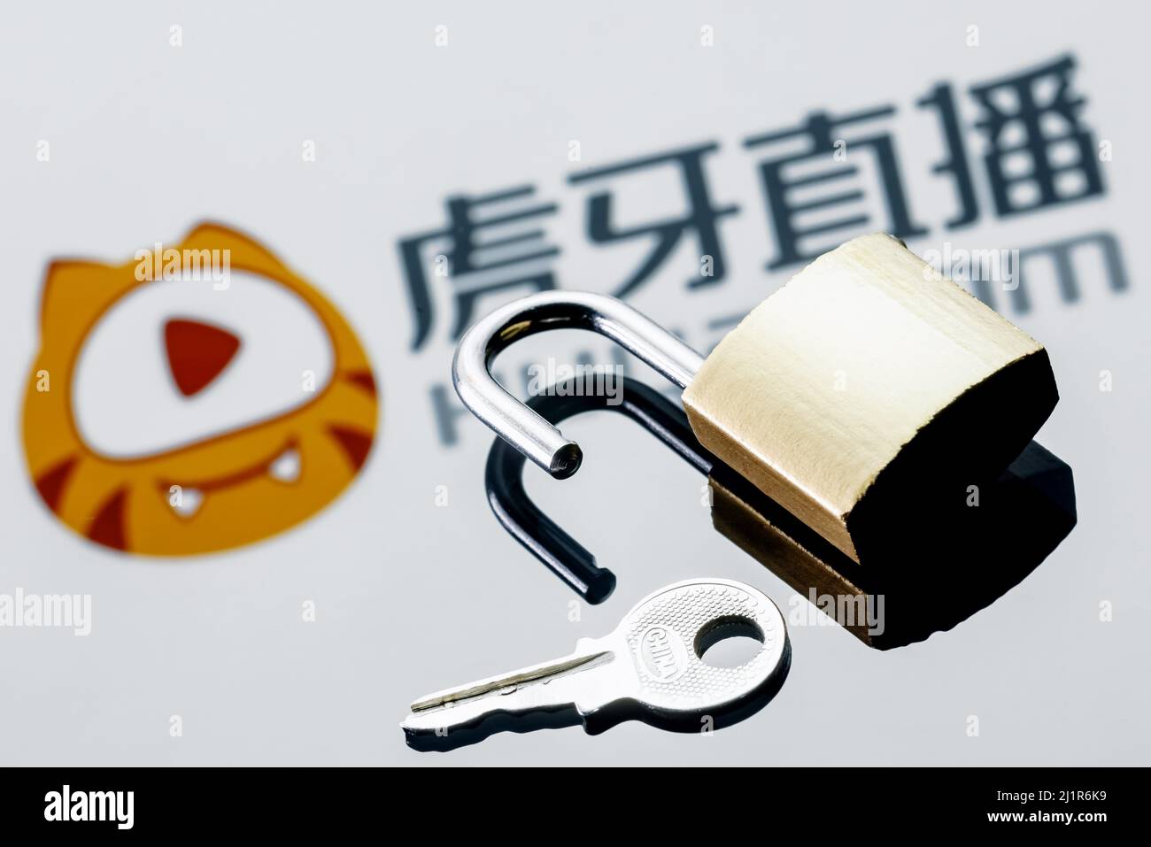 An open security lock and key on the background of the Huya live ...