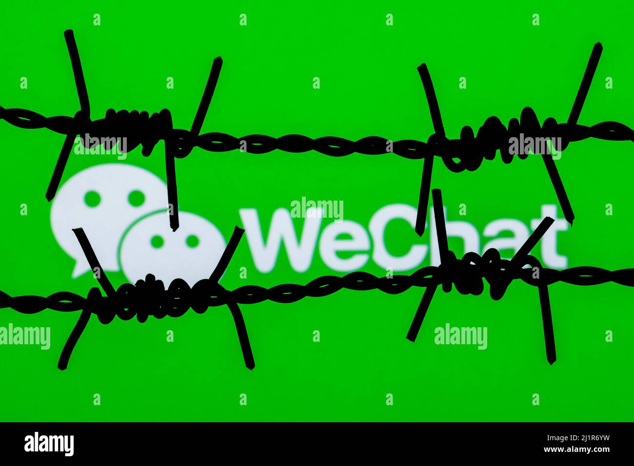 WeChat messenger logo behind barbed wire. The concept of WeChat ...