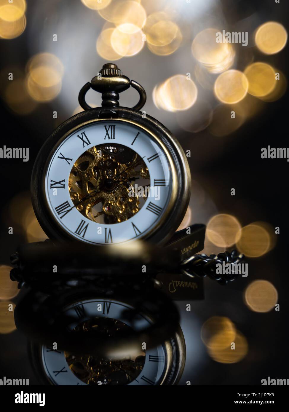 A closeup of gold pocket watches with background of light blurs Stock ...