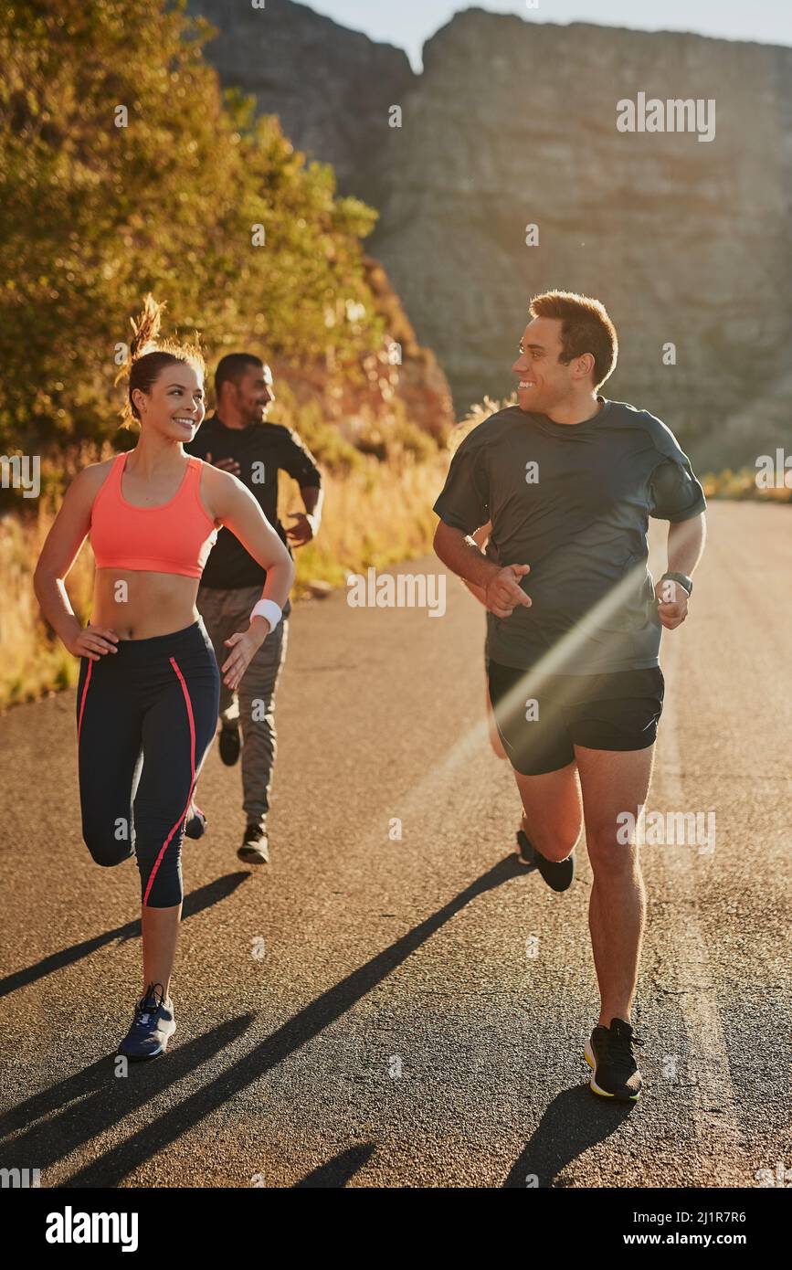 They encourage each other to go faster and farther. Shot of a fitness ...