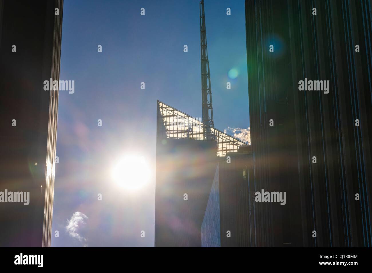 The sun shines among rows of high-rise buildings in Midtown Manhattan ...