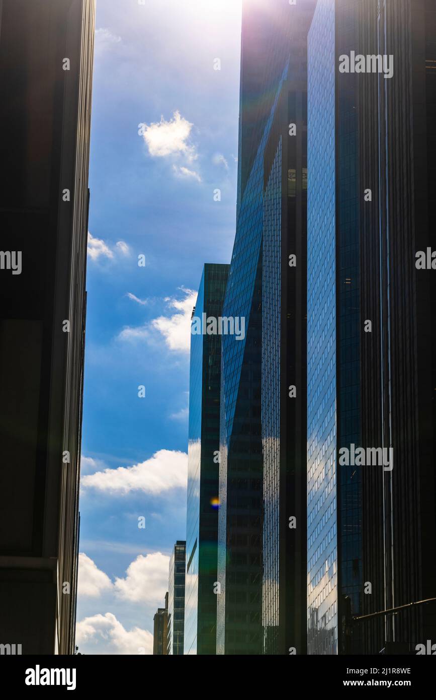 The sun shines among rows of high-rise buildings in Midtown Manhattan ...
