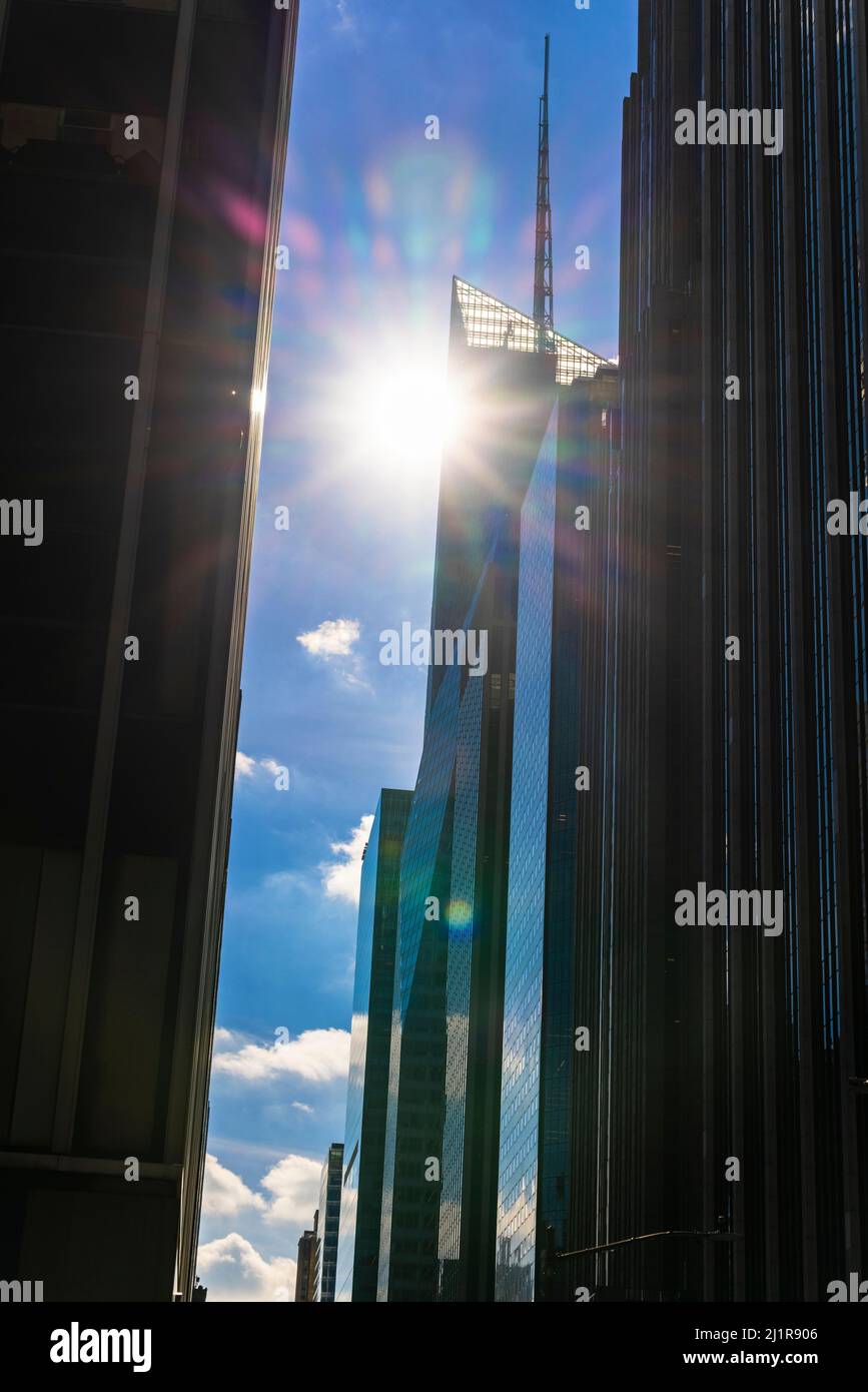 The sun shines among rows of high-rise buildings in Midtown Manhattan ...