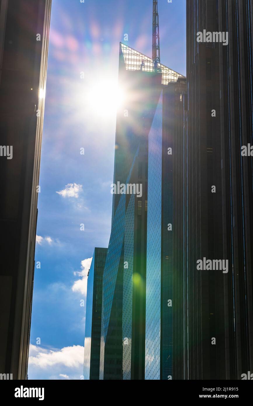 The sun shines among rows of high-rise buildings in Midtown Manhattan ...