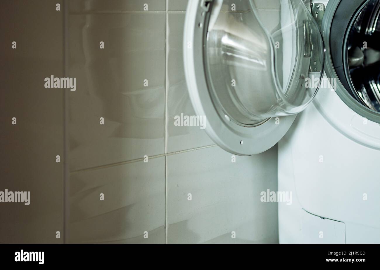 Modern washing machine near white wall indoors. Bathroom interior Stock ...
