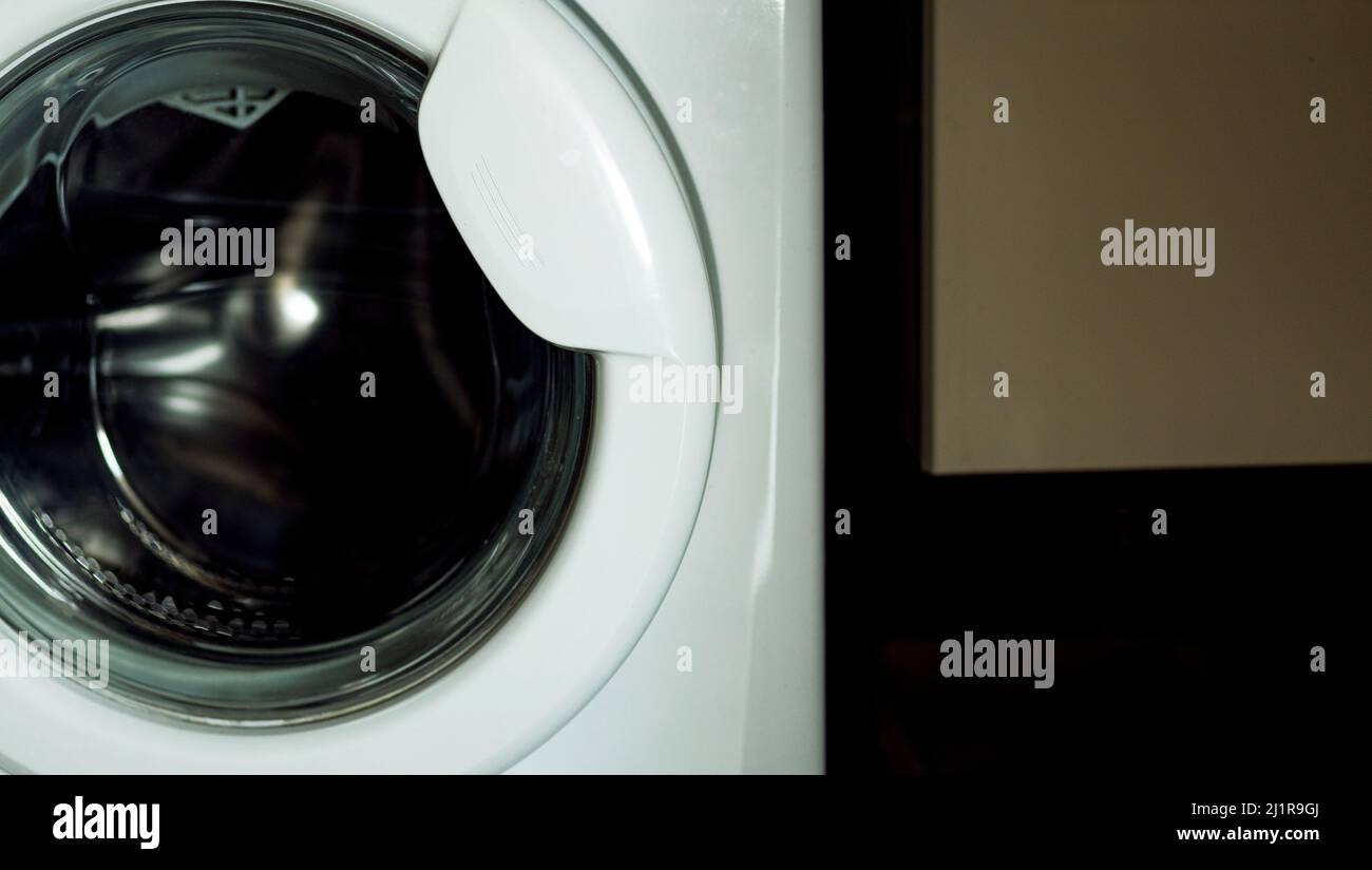 Household machine for washing fabric laundry with lid for loading in a ...