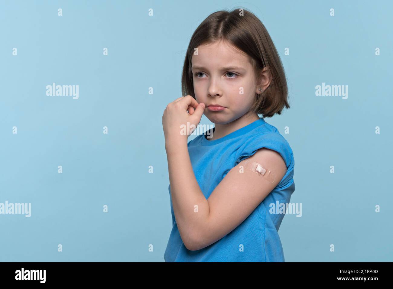 Upset, sad emotional Child shows vaccinated arm after Being Injected ...